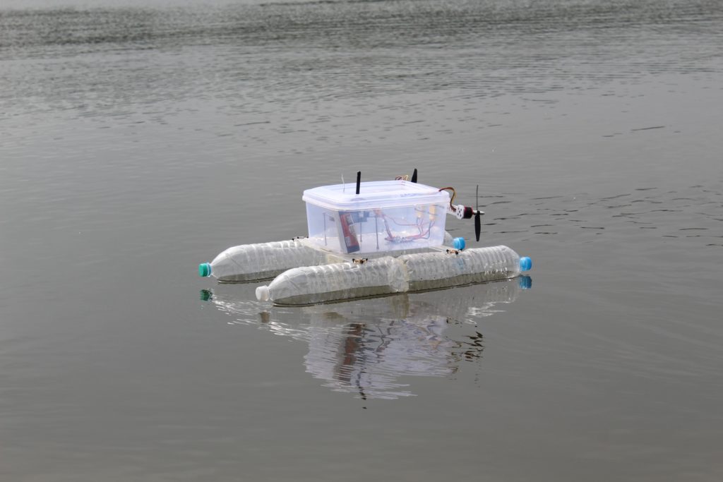 Small-scale autonomous boat made out of recycled water bottles and a T ...